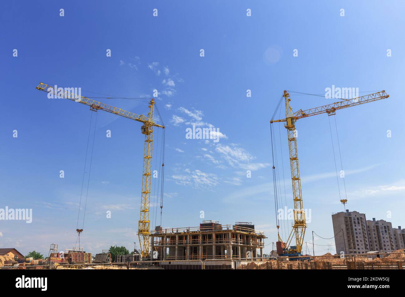 Crane and building construction site against blue sky. Concrete ...