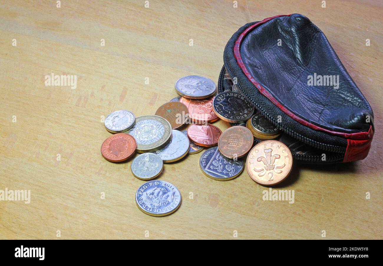 Dropped purse on the floor with coins falling out of it Stock Photo - Alamy
