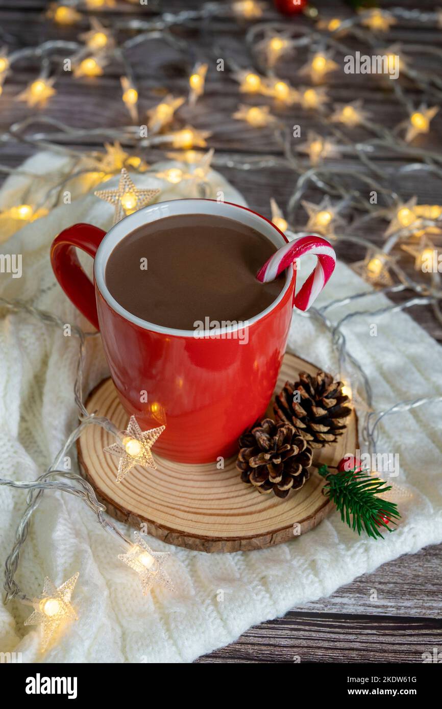 Hot chocolateand a candy cane, warm cozy Christmas drink in a dark ...