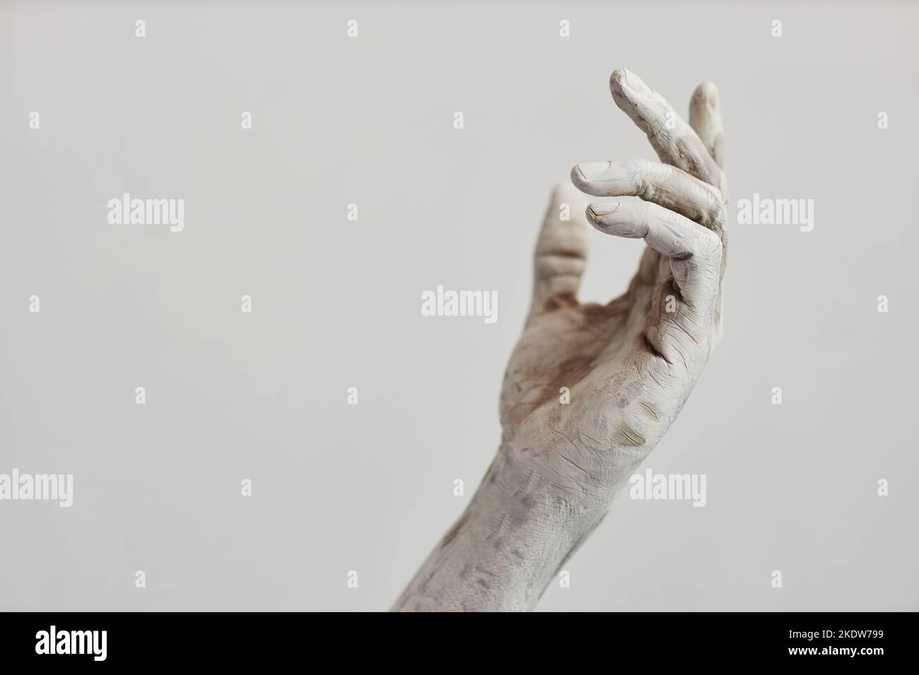 Minimal closeup of male hand covered in white paint or plaster, human ...