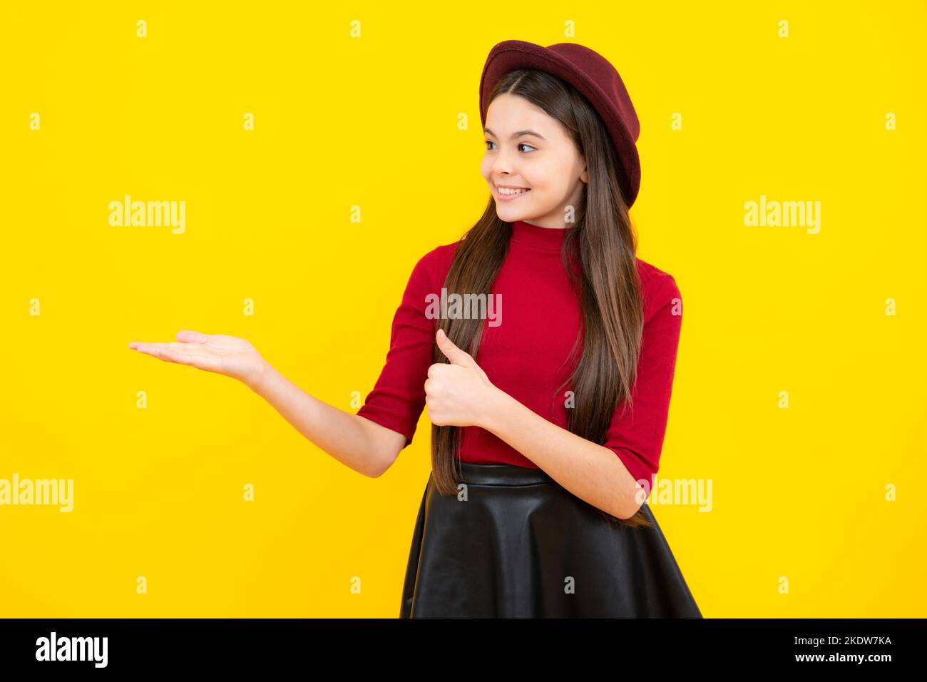 Look at advert. Teenager child points aside shows blank copy space for ...