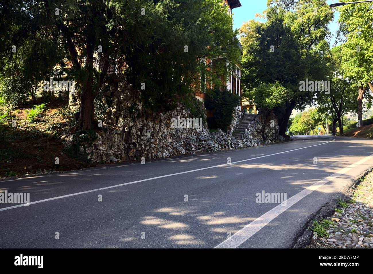 Uphill road next to a building in an italian town Stock Photo - Alamy