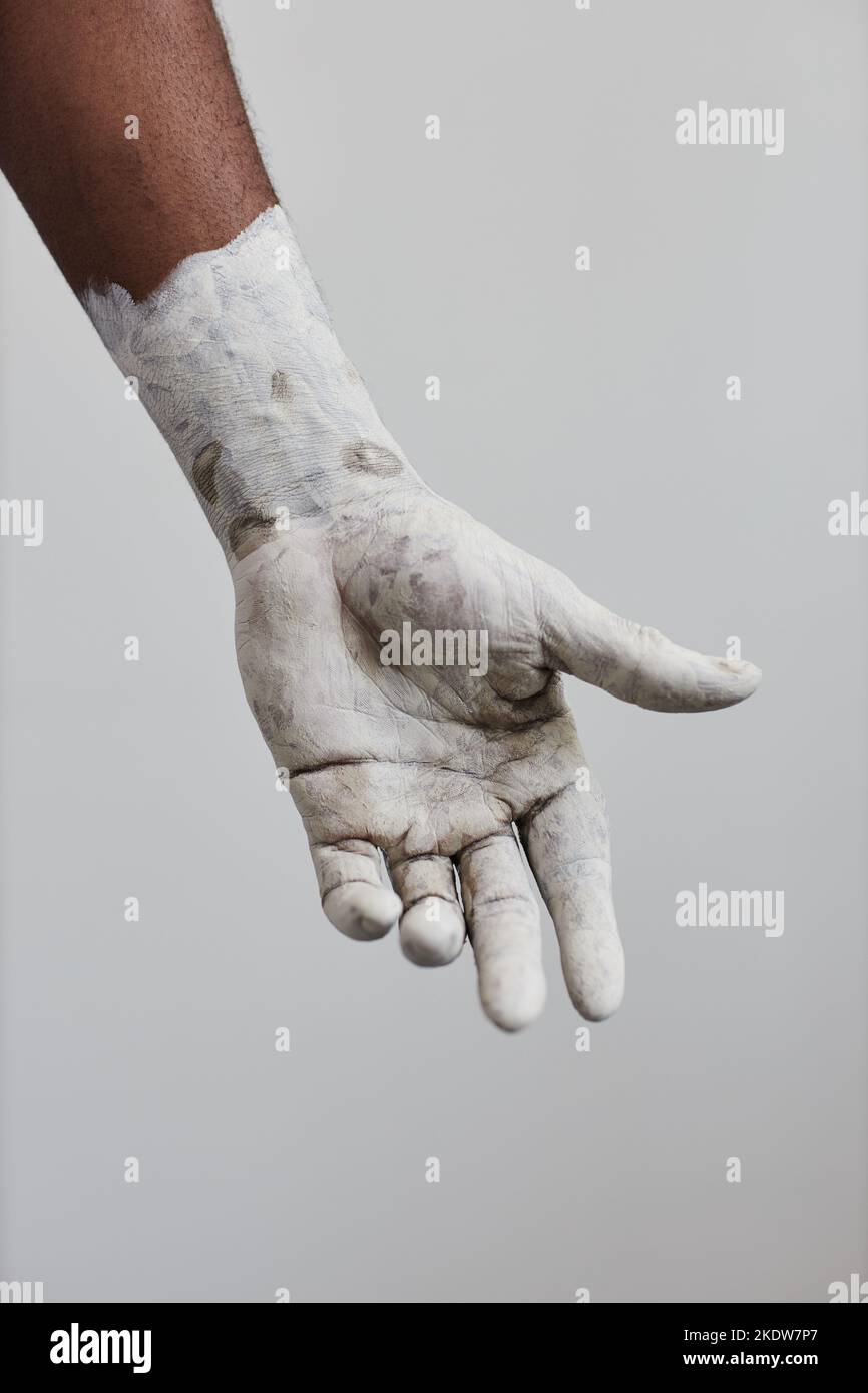 Vertical closeup of male hand covered in white paint, minimal Stock ...