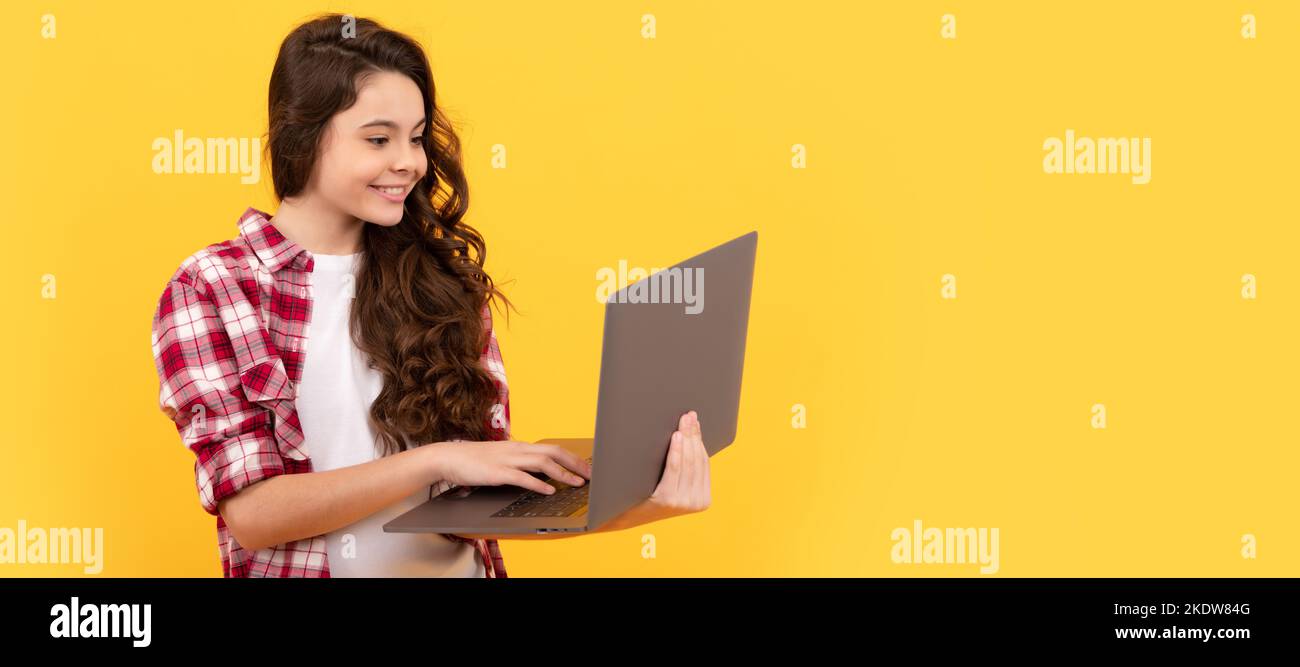 happy smart kid typing on laptop during school online lesson, modern ...