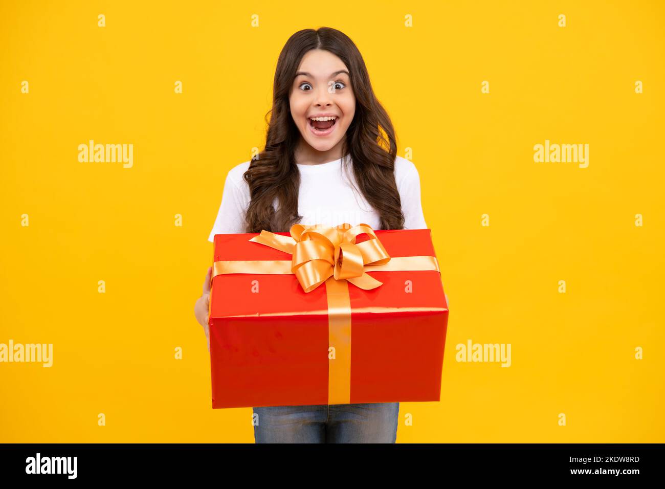 Amazed teenager. Teenager kid with present box. Teen girl giving ...