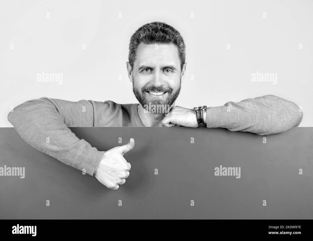 presenting novelty information. male behind pink paper show thumb up ...