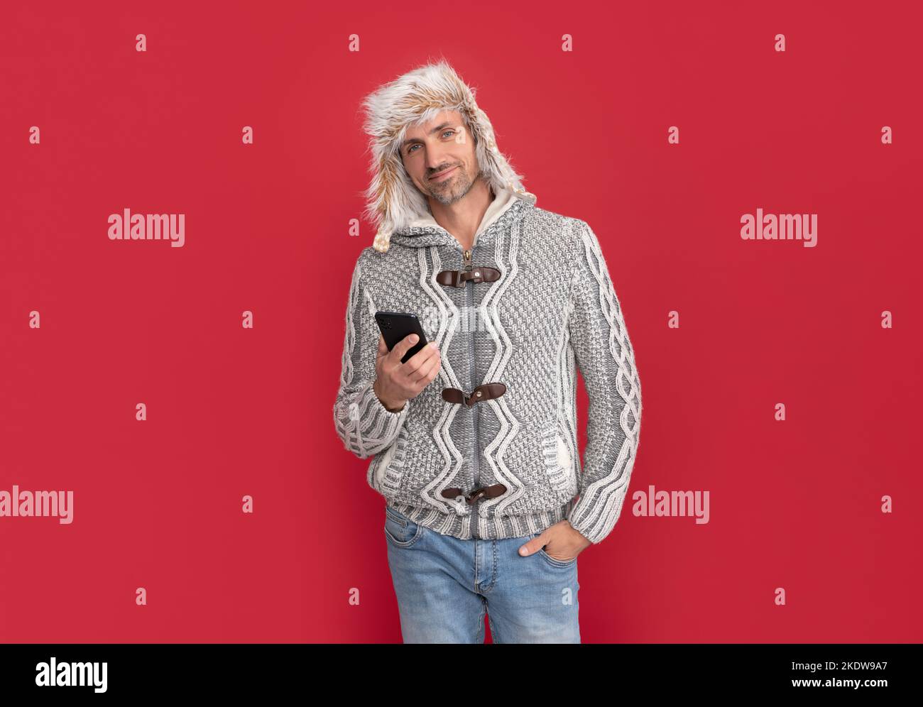 smiling male fashion model hold smartphone. concept of modern ...