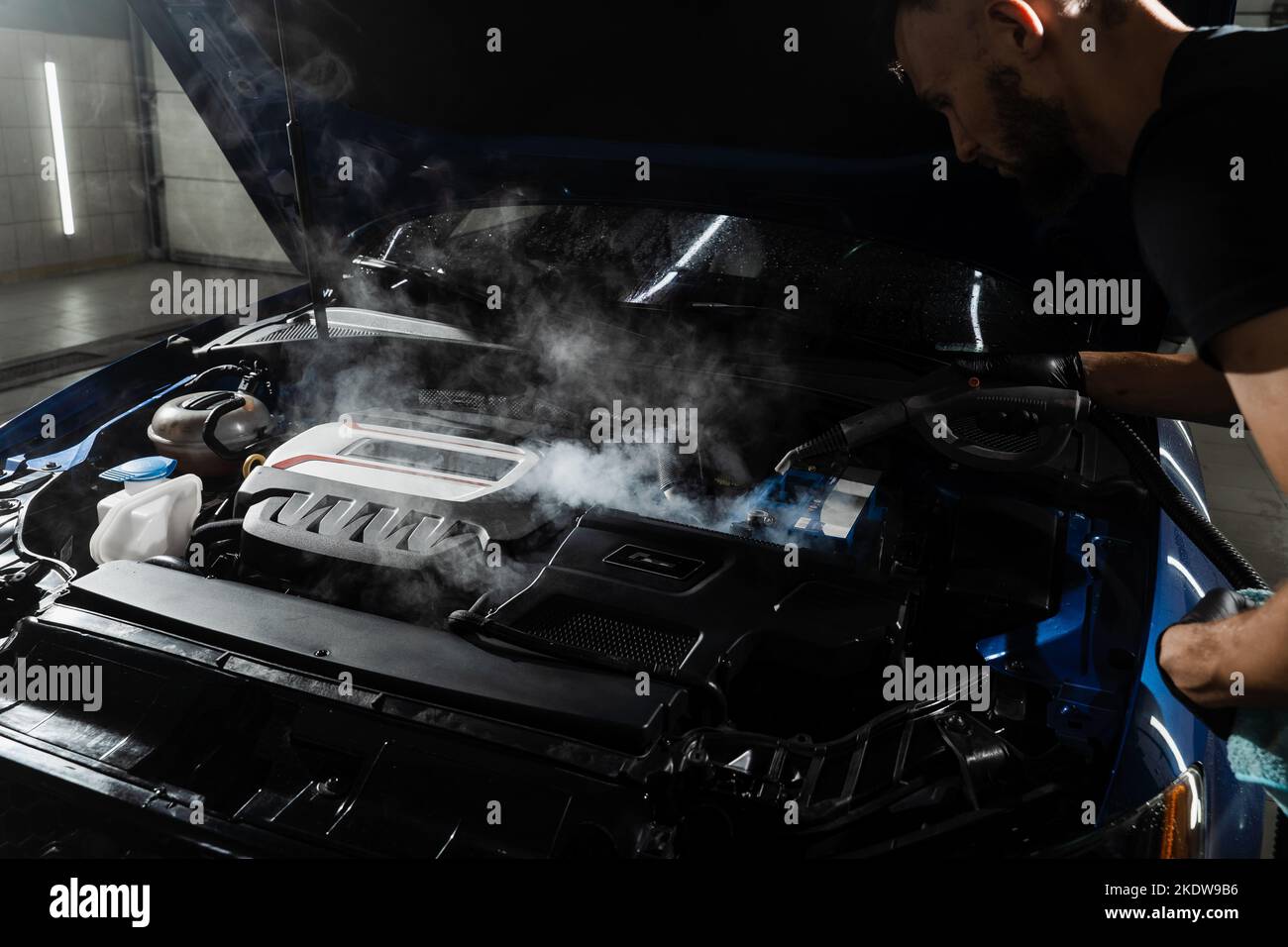 Steaming washing of motor of auto in detailing auto service. Process of ...