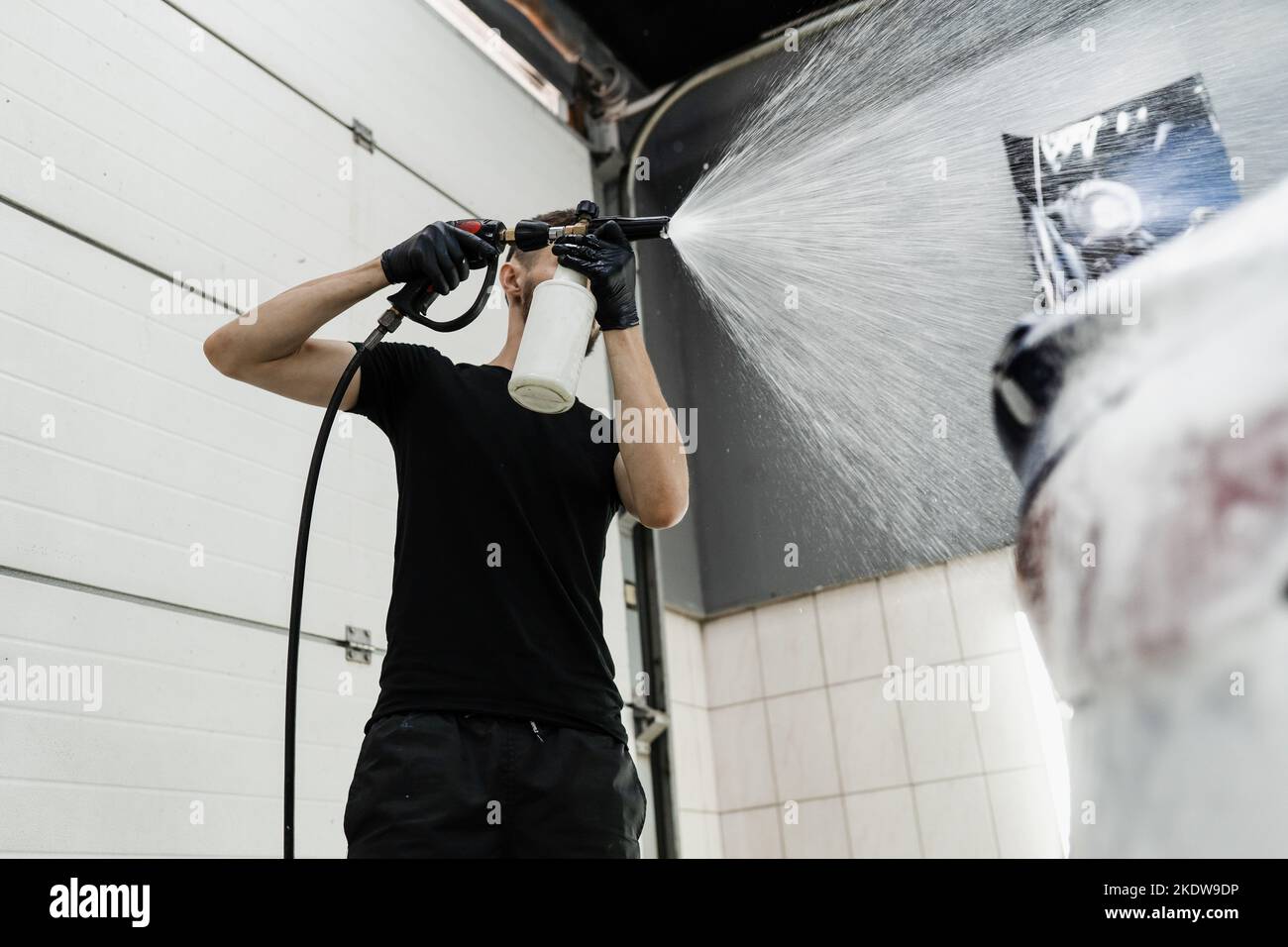 Second phase of detailing washing in car service. Car washer does full ...
