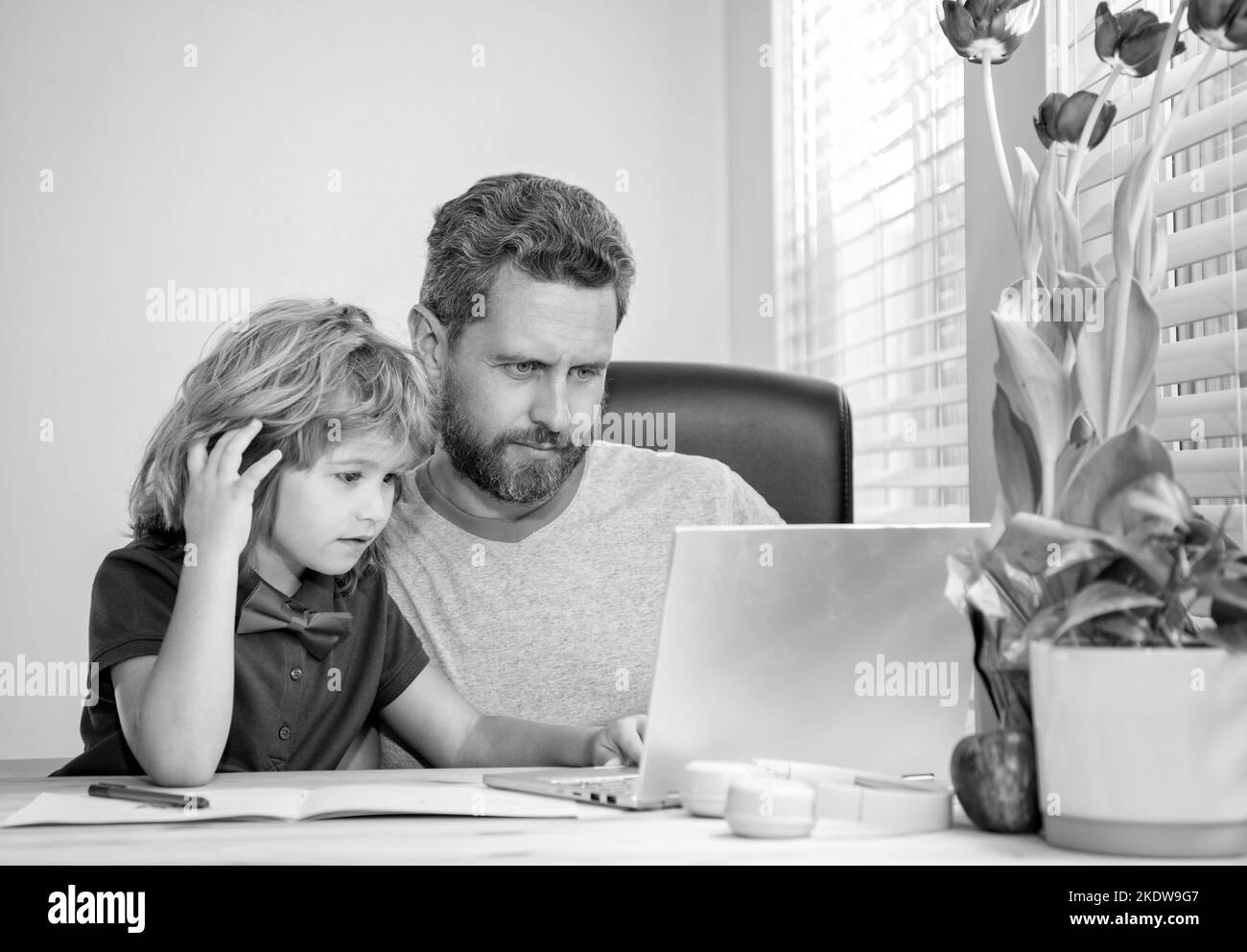 homeschooling and elearning. back to school. father and child use ...