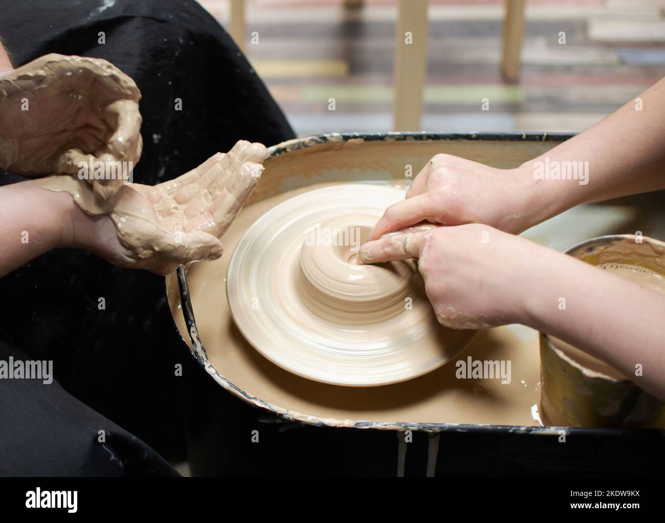 Man and woman sculpt with clay. Clay modeling training on a potters ...