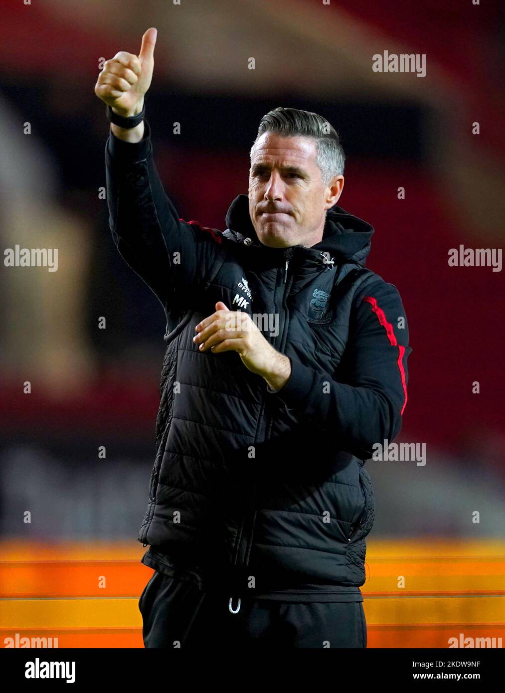 Lincoln City manager Mark Kennedy gestures to the fans at the end of ...