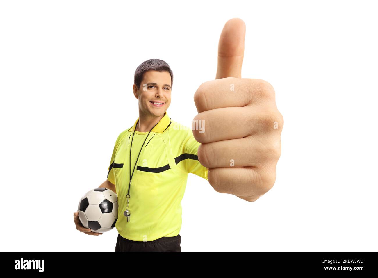 Football referee holding a ball and a gesturing thumb up sign isolated ...