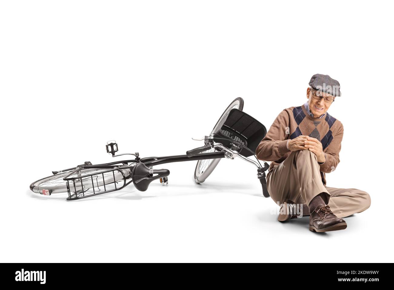 Senior falling off a bicycle and holding his painful knee isolated on ...