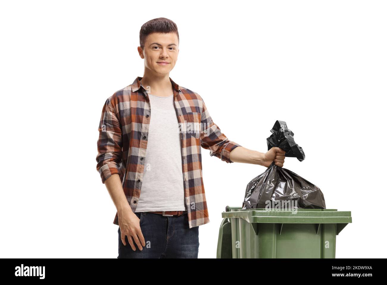 Smiling young man throwing a waste bag in a bin isolated on white ...