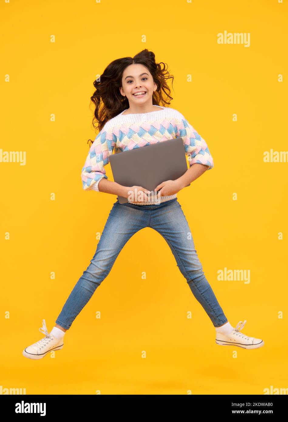 Student school girl with laptop on isolated studio background. Run and ...