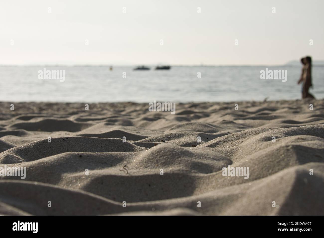 Lapaman beach defocused background with people walking Stock Photo - Alamy