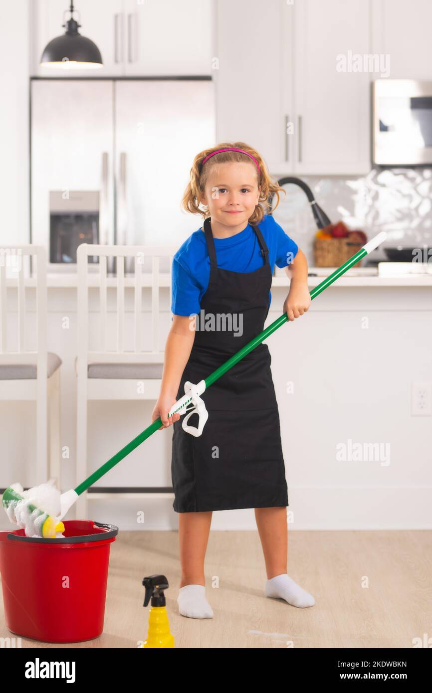 Kid helping with housework, cleaning. Portrait of child helping with ...