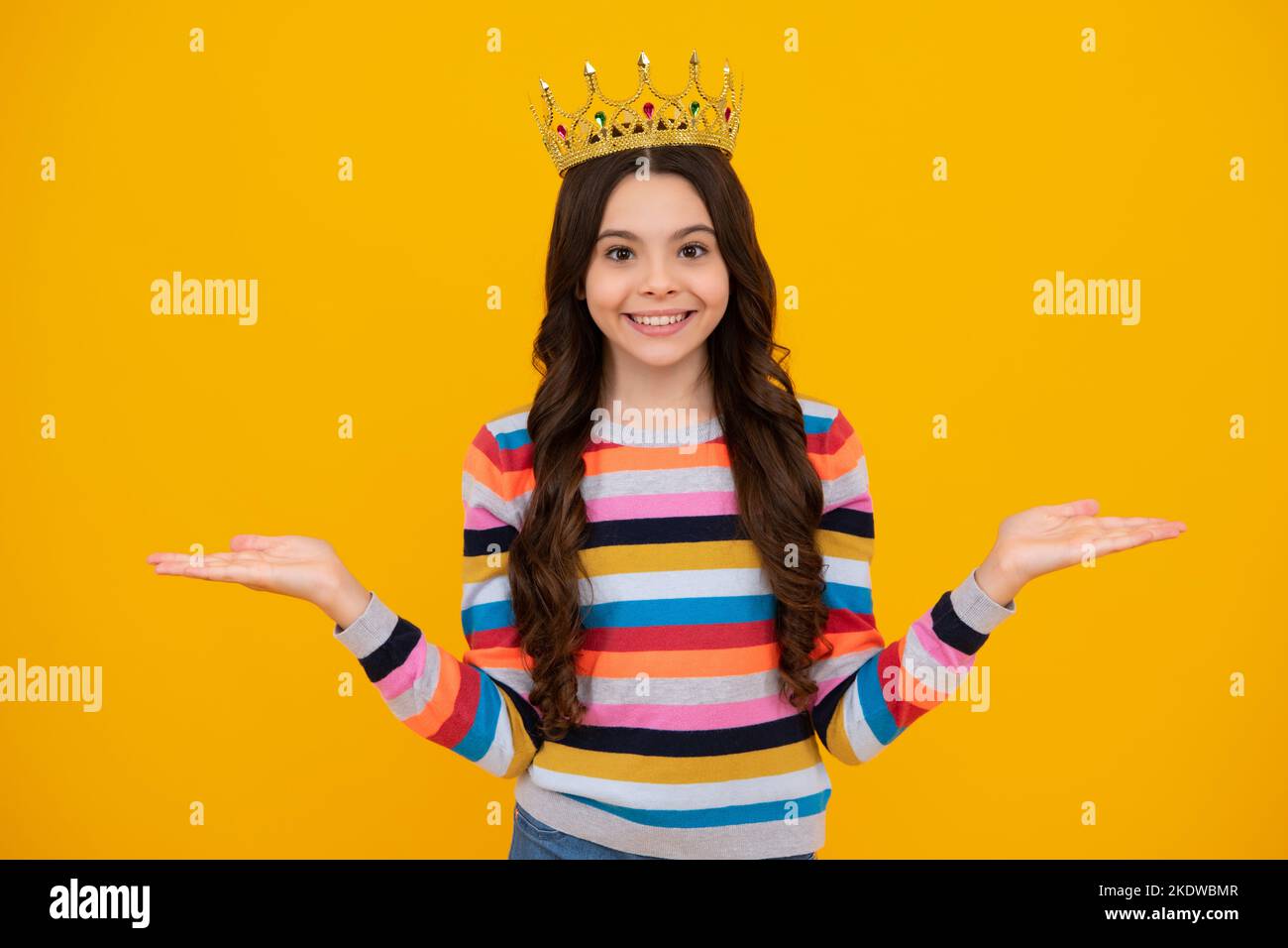 Little queen wearing golden crown. Teenage girl princess holding crown ...