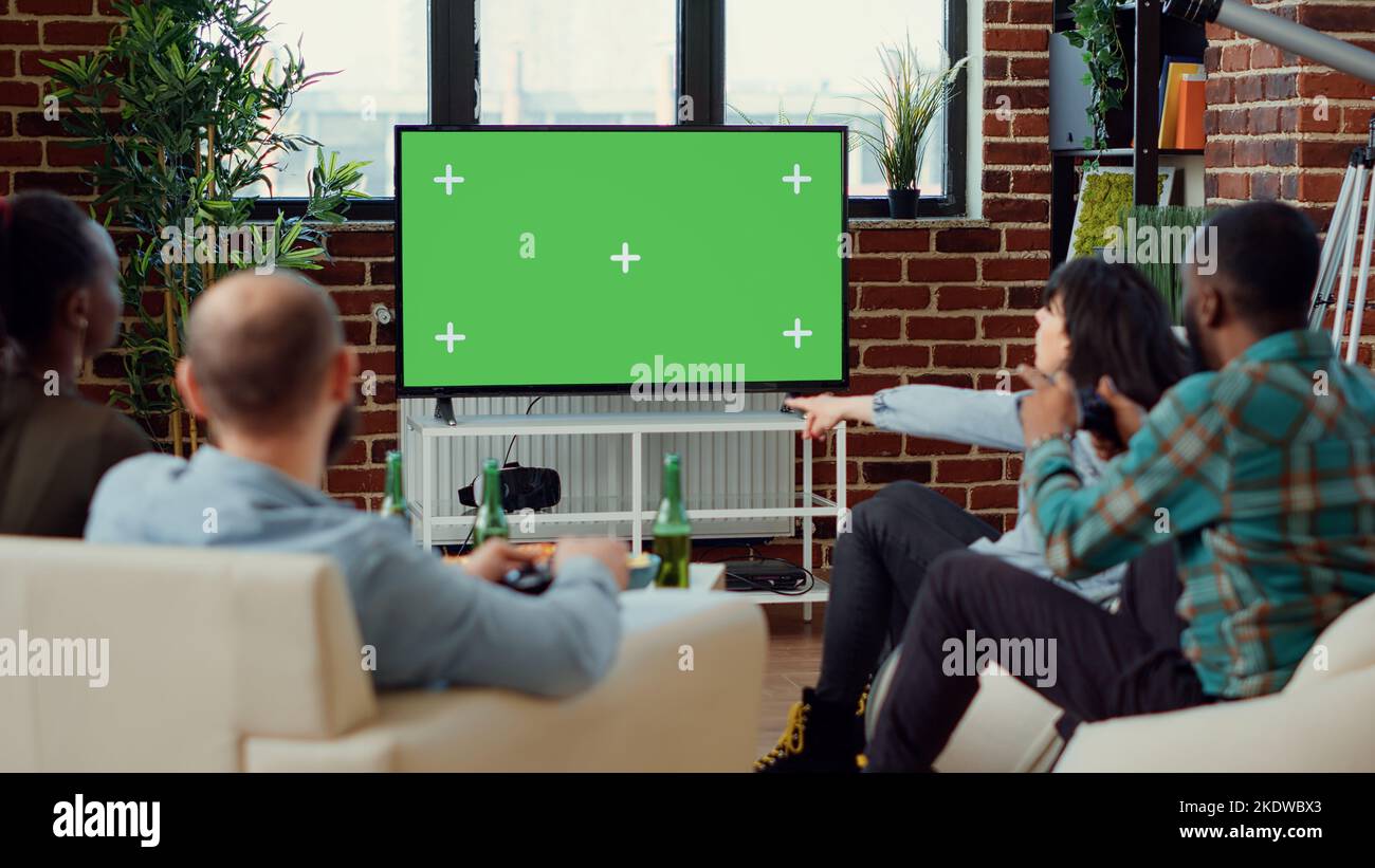 Group of people using greenscreen template to play video games, having ...