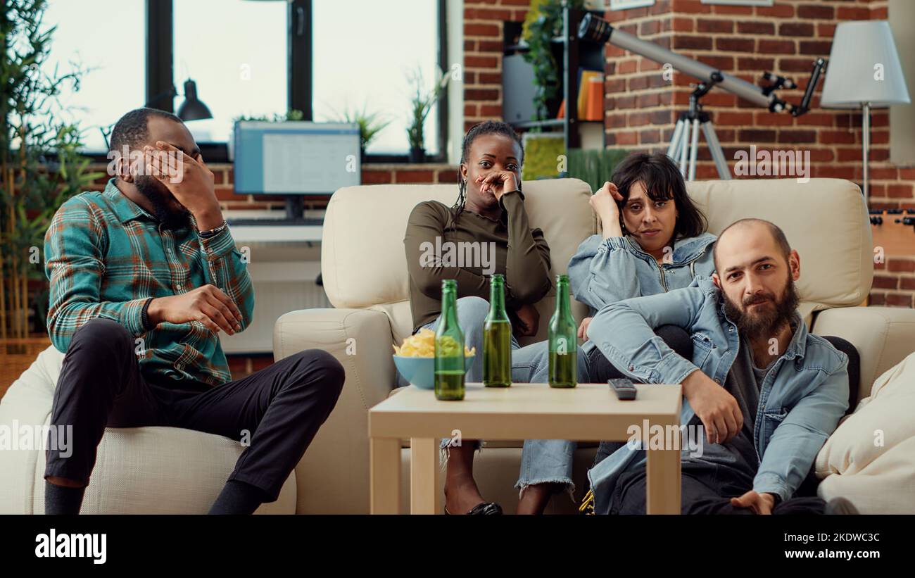 Diverse people getting scared watching horror thriller film, having ...