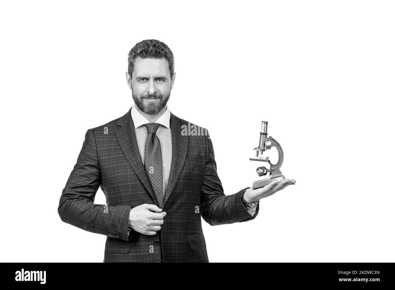 entrepreneur man in businesslike suit presenting modern microscope ...