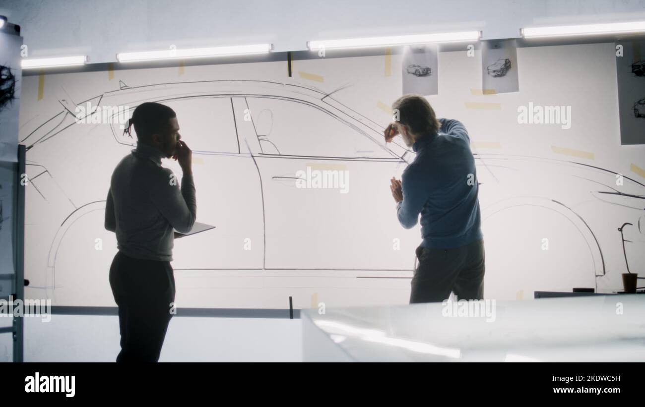 Two diverse automotive male designers discussing and developing ...