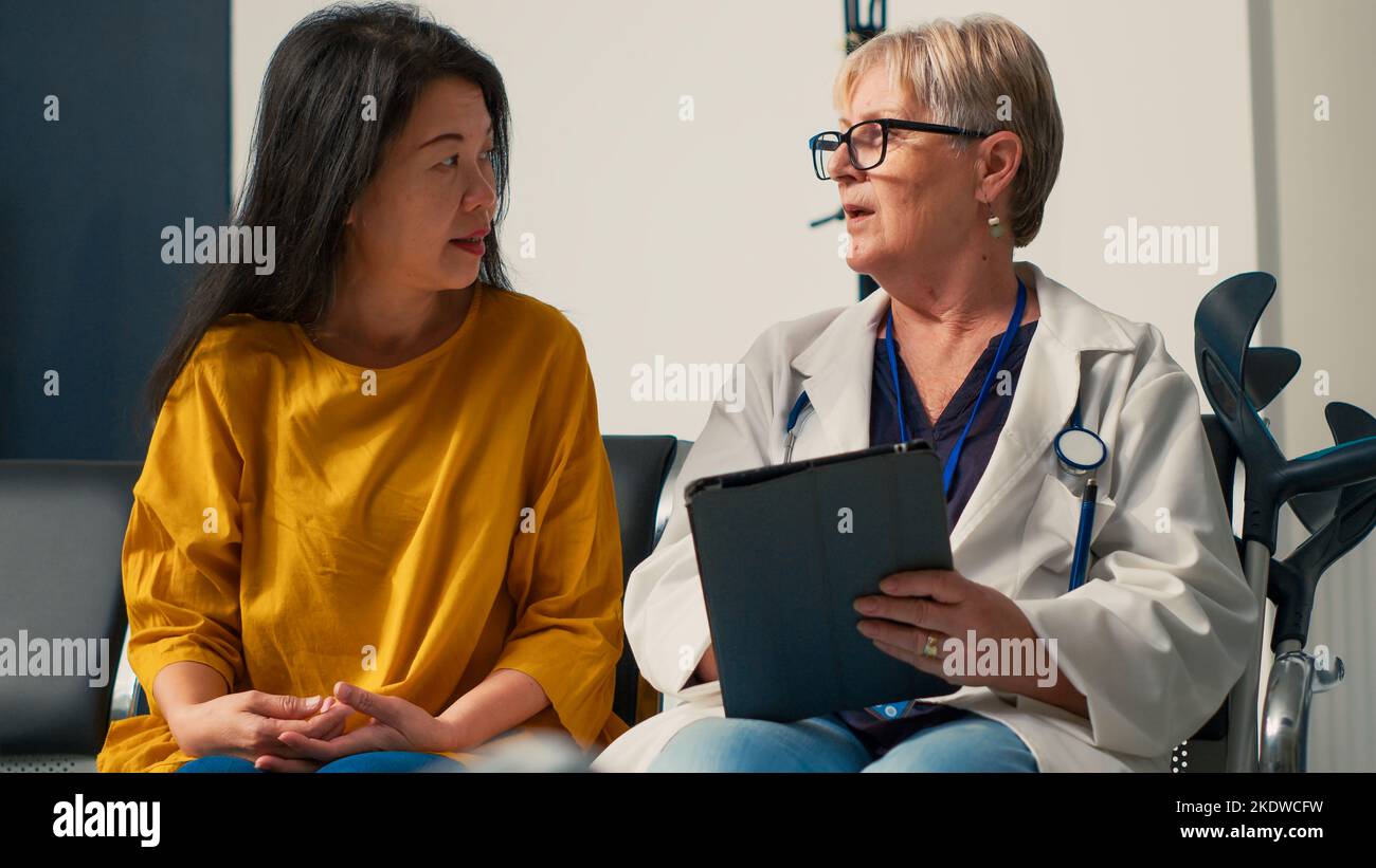 Asian patient doing checkup examination with elderly medic, receiving ...