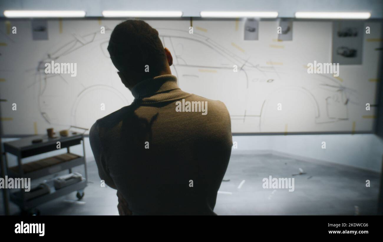Back view of automotive african american male designer drawing sketch ...