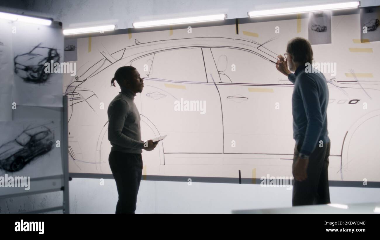 Two diverse automotive male designers discussing and developing ...
