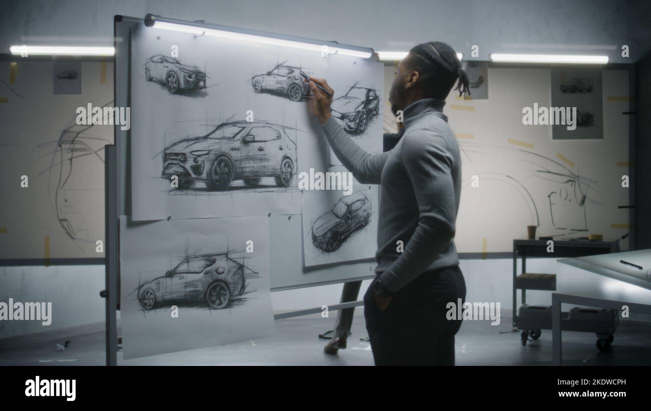 Two diverse automotive male designers drawing sketches with marker on ...