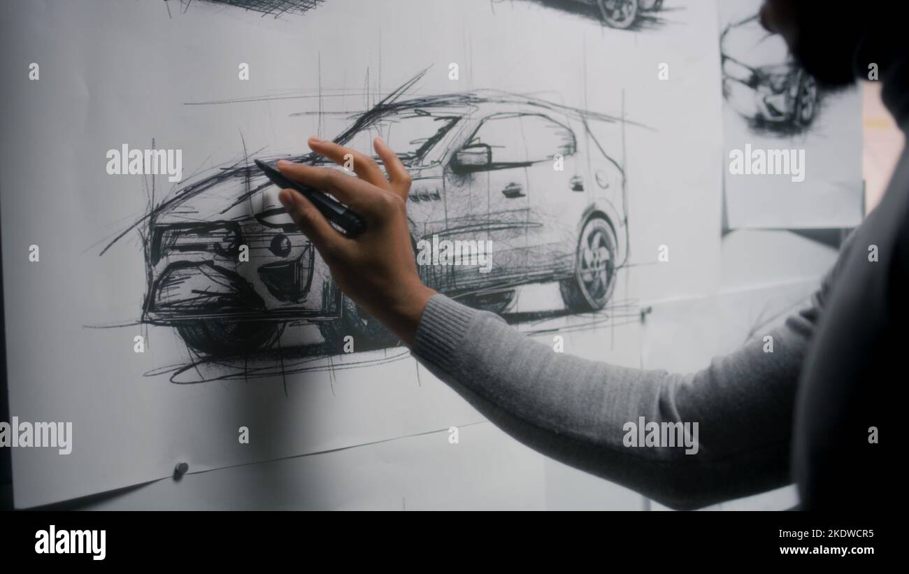 Automotive african american male designer drawing sketch blueprint with ...