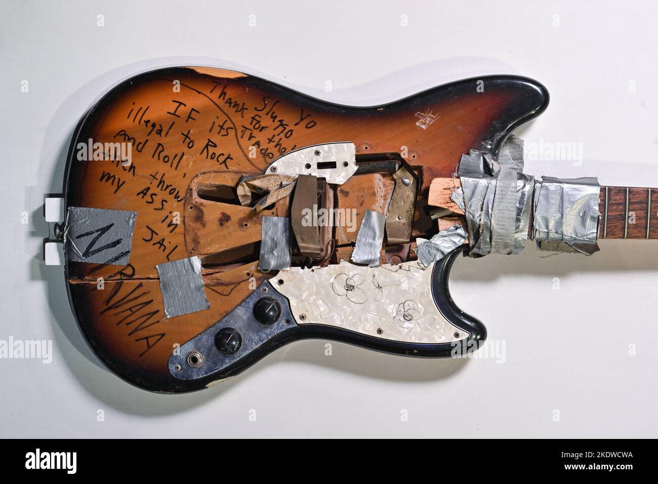 A 1973 Fender Mustang guitar owned, stage-played, smashed and signed by ... A 1973 Fender Mustang guitar owned, stage-played, smashed and signed by ...