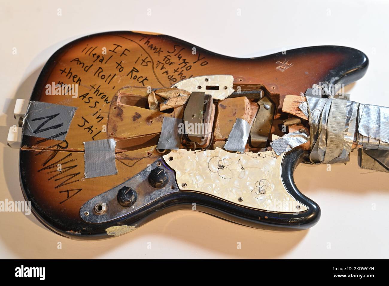 A 1973 Fender Mustang guitar owned, stage-played, smashed and signed by ...