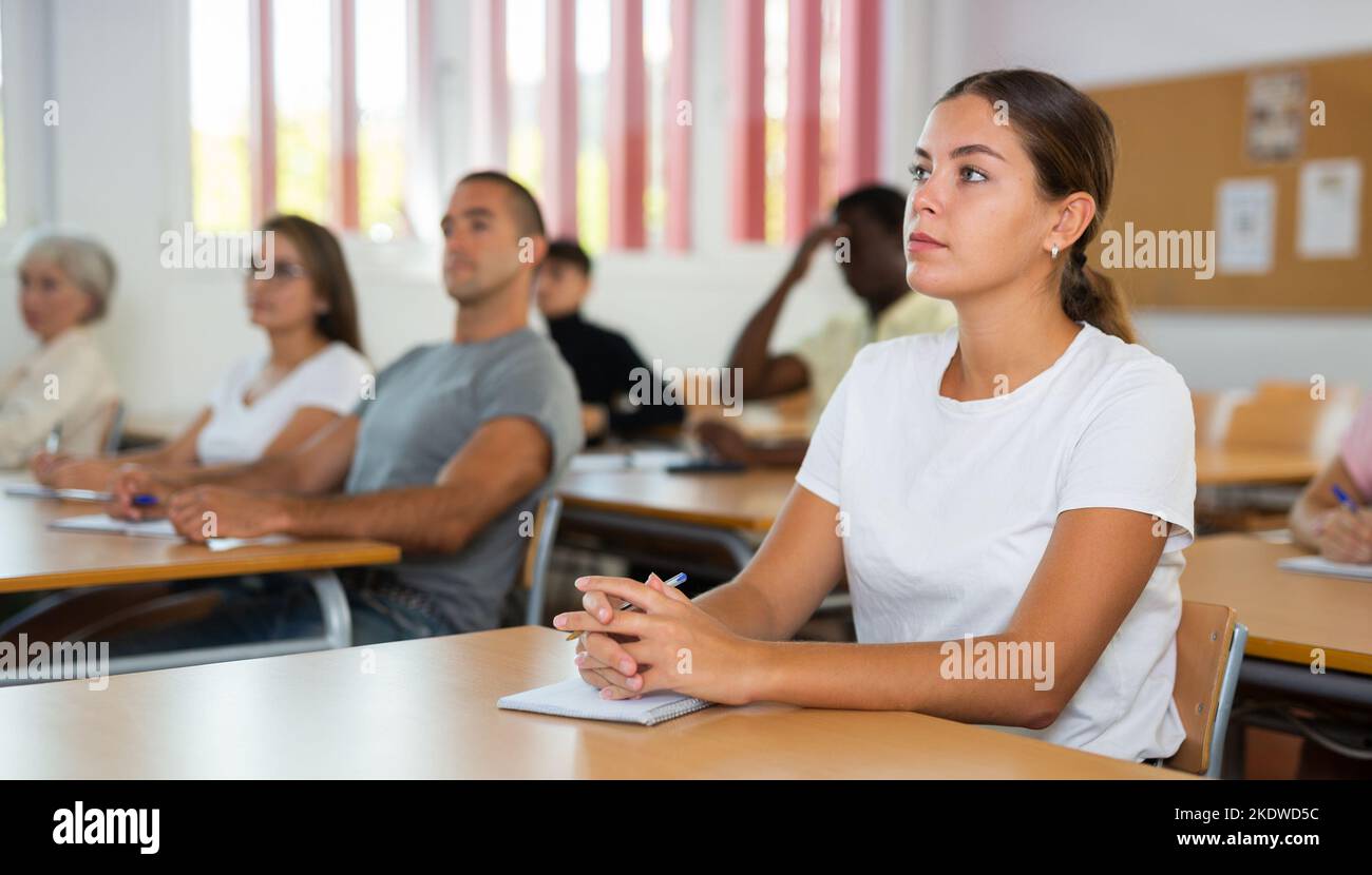 Young woman attending lecture in classroom Stock Photo - Alamy