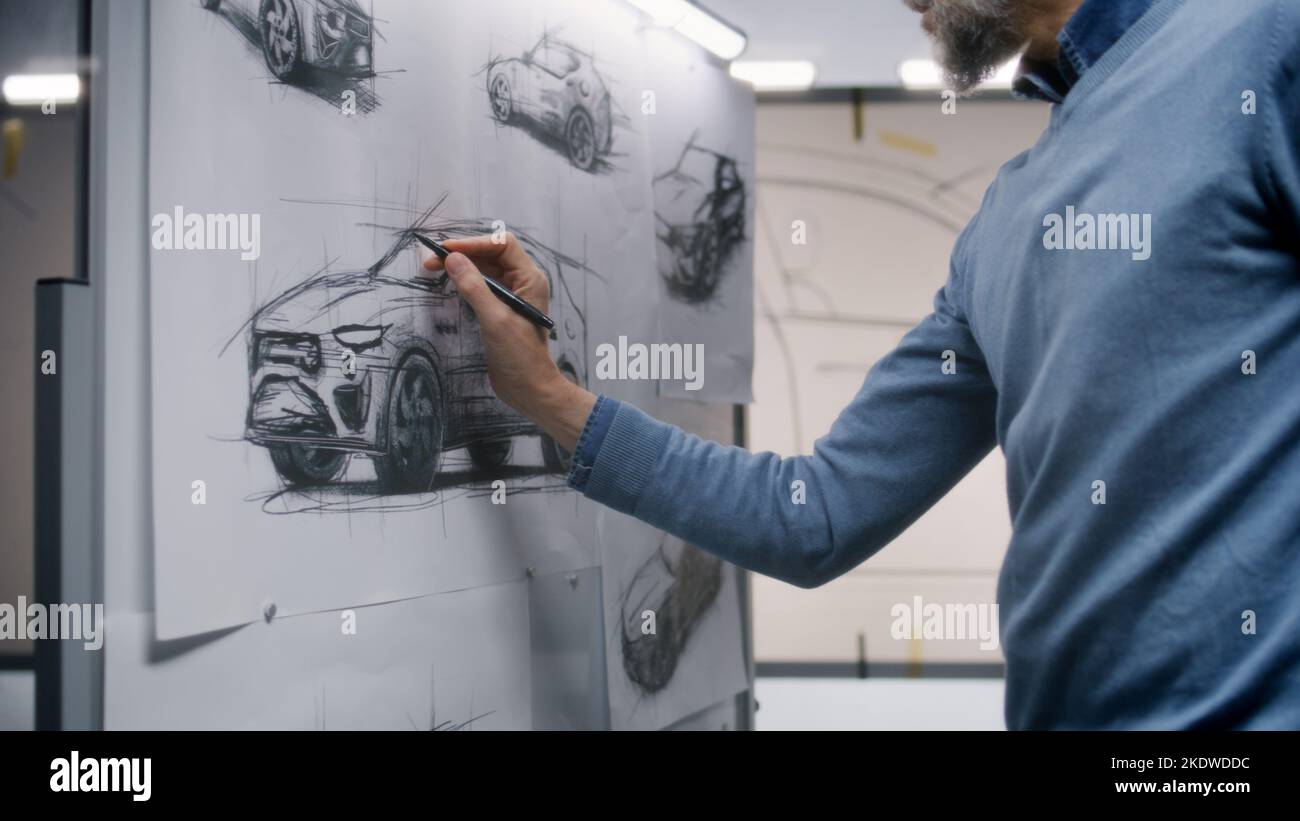 Two diverse automotive male designers discussing and developing ...