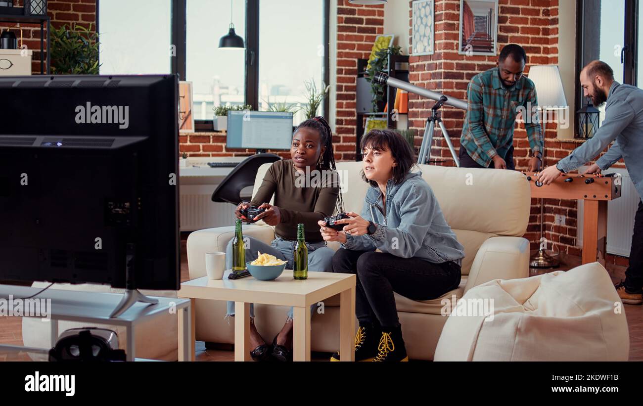 Multiethnic group of people losing video games challenge on tv console ...