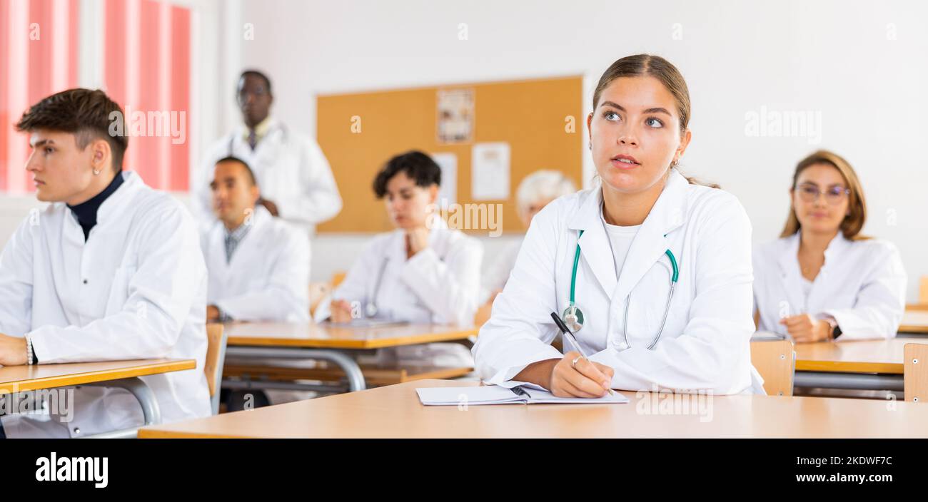 Girl medical student listening to lecture in classroom Stock Photo - Alamy