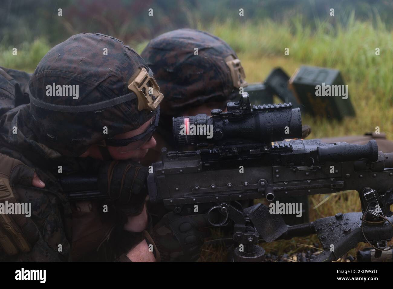 U.S. Marines with 3d Battalion, 3d Marines fire a M240B machine gun at ...