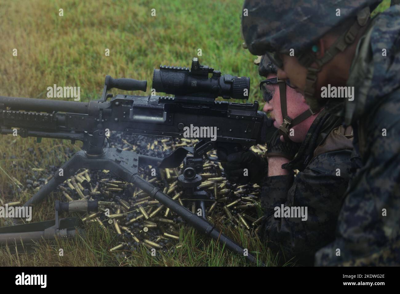 U.S. Marines with 3d Battalion, 3d Marines fire a M240B machine gun at ...