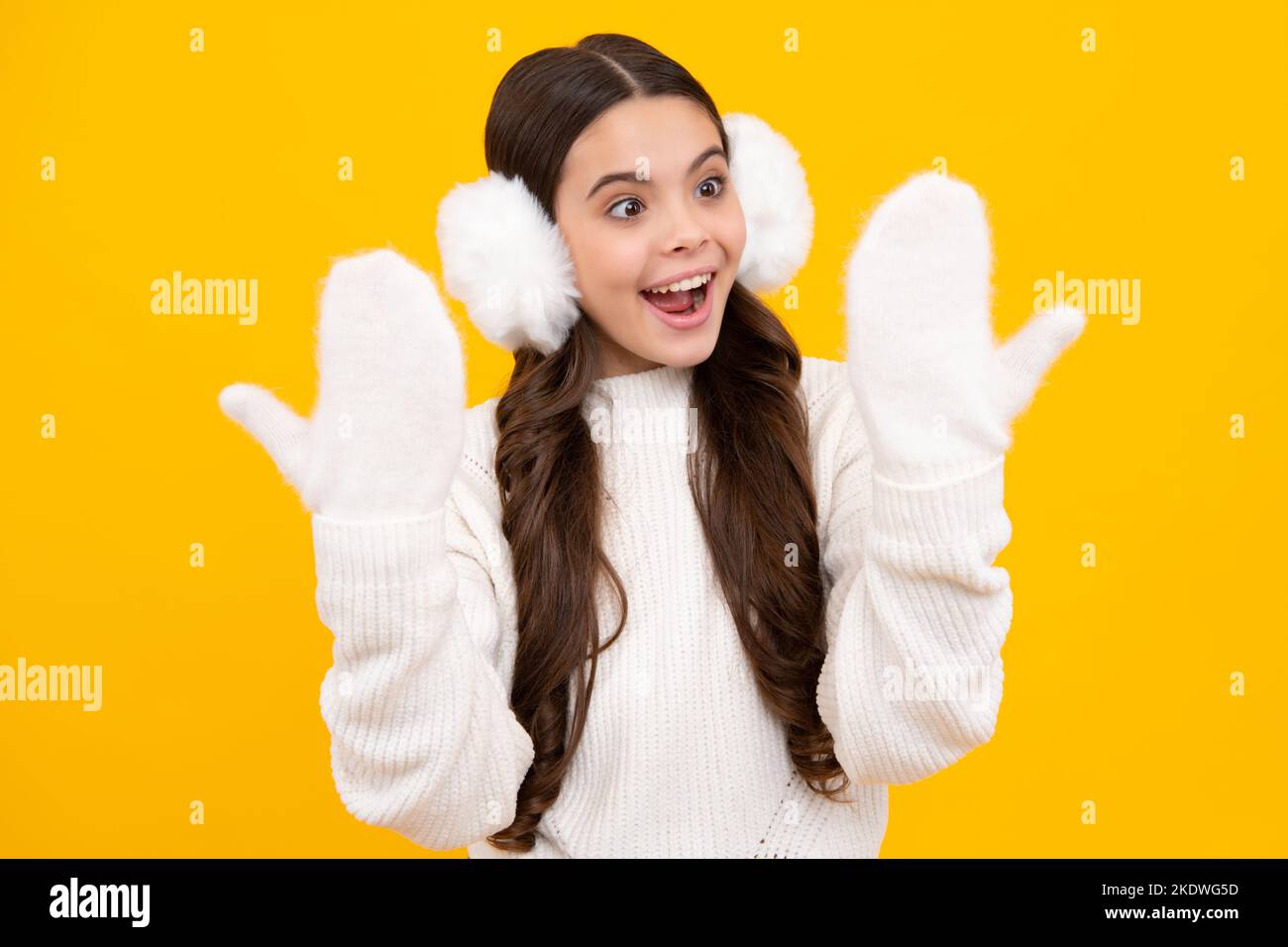 School girl in winter clothes and winter warm earmuff ear-flaps ...