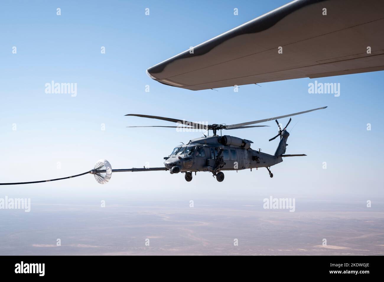 A U.S. Air Force HH-60G Pave Hawk receives fuel from a HC-130J Combat ...