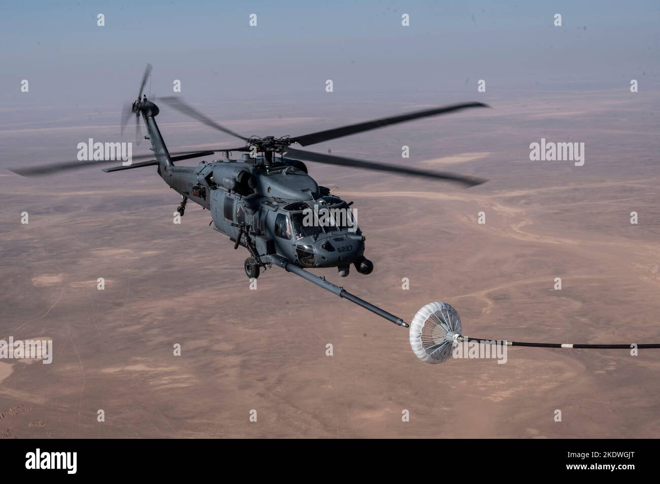 A U.S. Air Force HH-60G Pave Hawk receives fuel from a HC-130J Combat ...