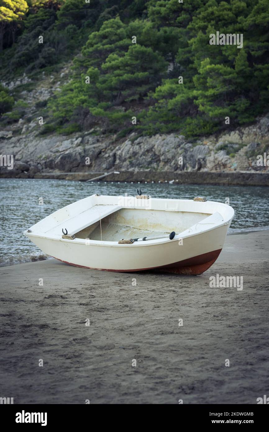 White Rowboat on a deserted beach Stock Photo - Alamy