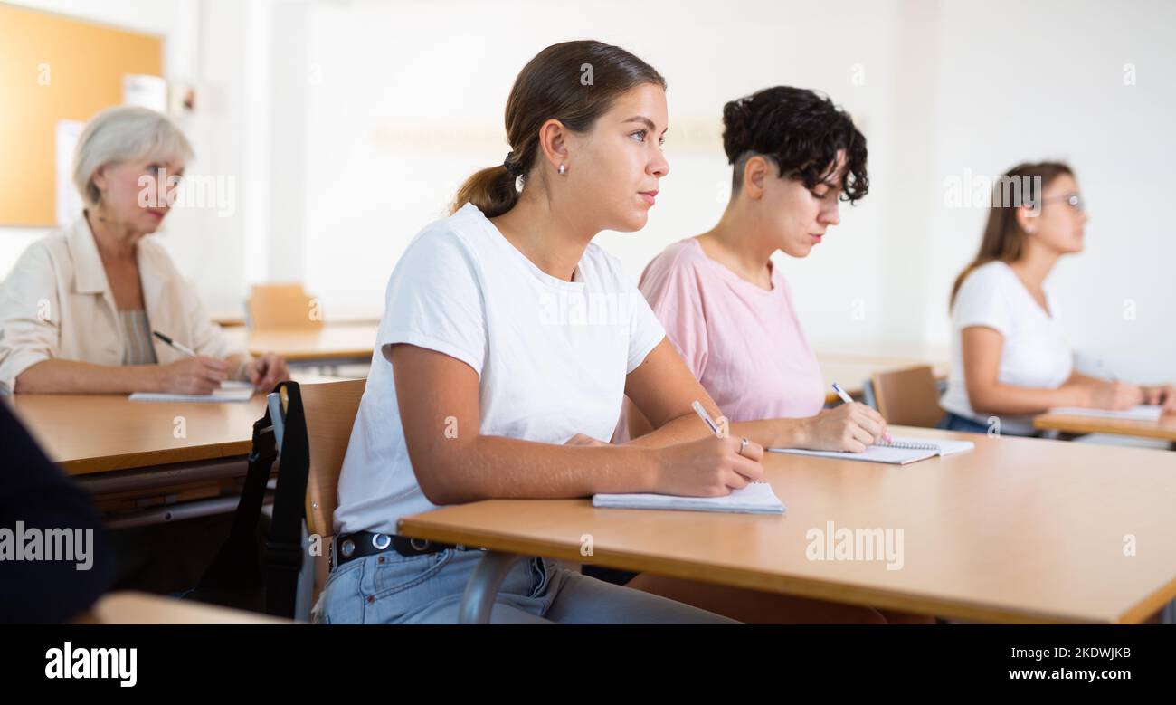 Young woman learning language in classroom Stock Photo - Alamy