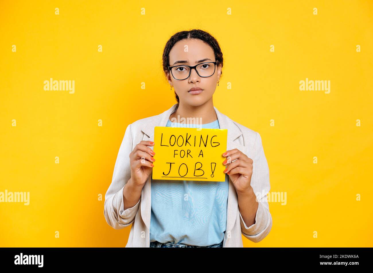 Frustrated sad mixed race young woman with glasses, creative specialist ...