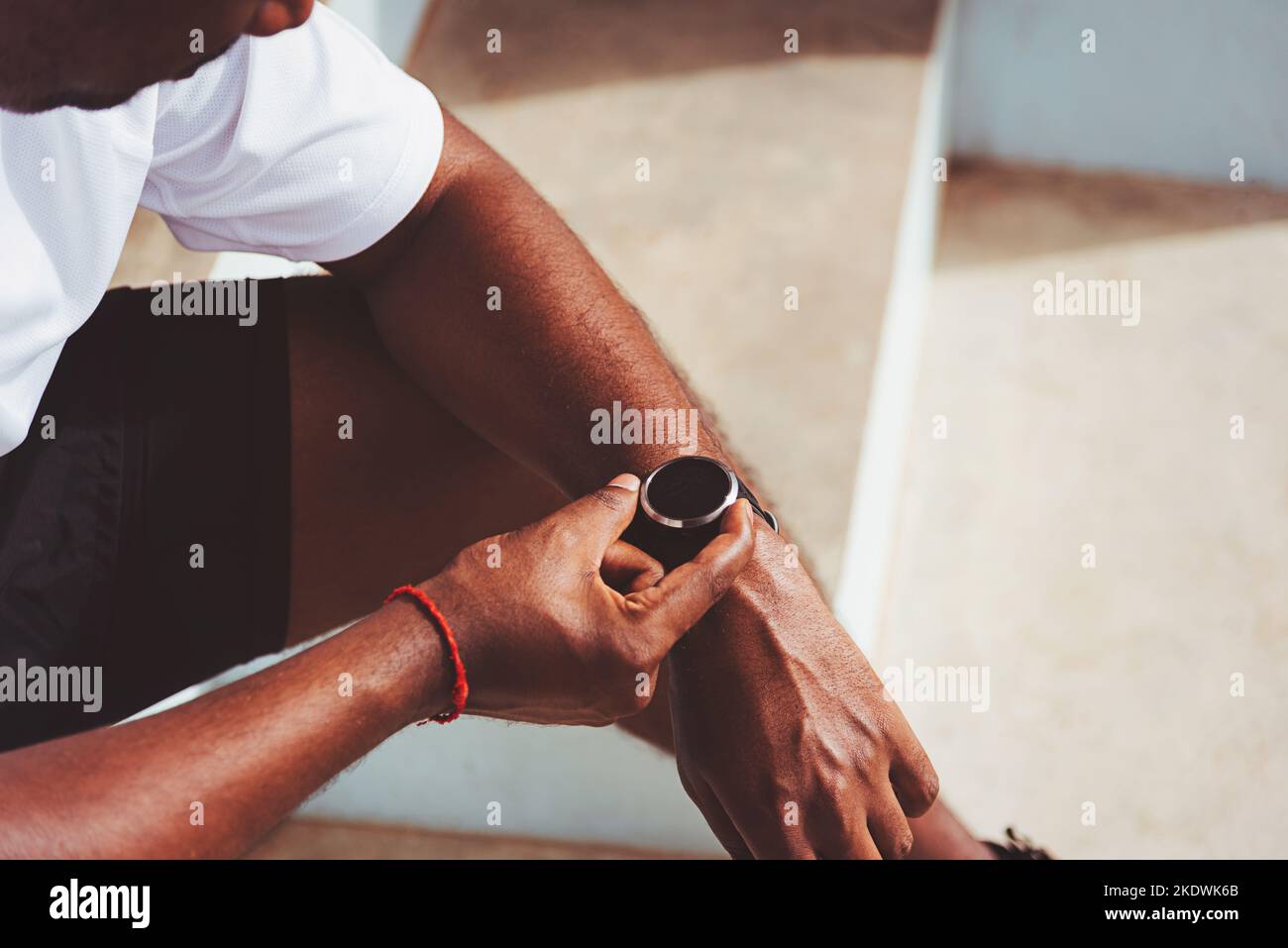 sport runner black man wear modern time smart watch he sitting resting ...