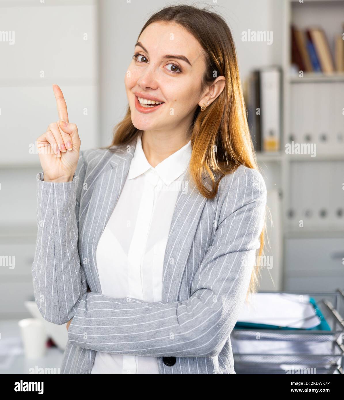 Woman office worker standing and pointing finger at camera Stock Photo ...