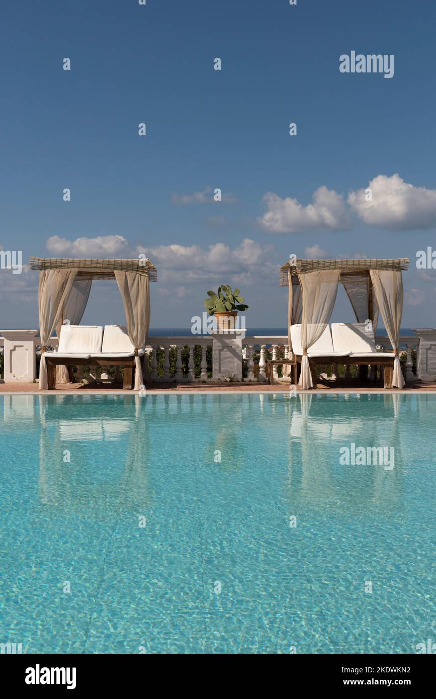 Crete, Greece.2022. Sunbeds with drapes and mattress for two siuated ...