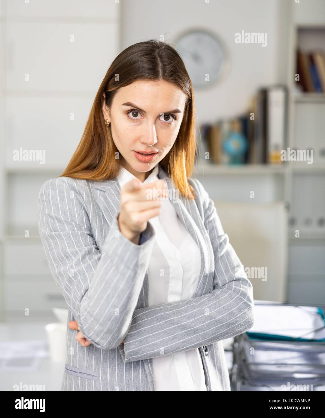 Woman office worker standing and pointing finger at camera Stock Photo ...
